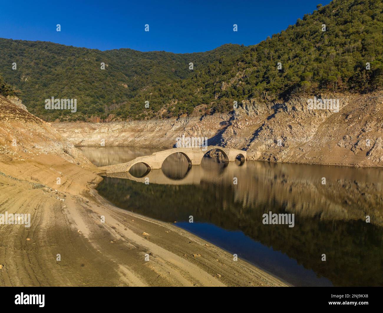Aerial view of the medieval bridge of Querós, in the Susqueda reservoir ...