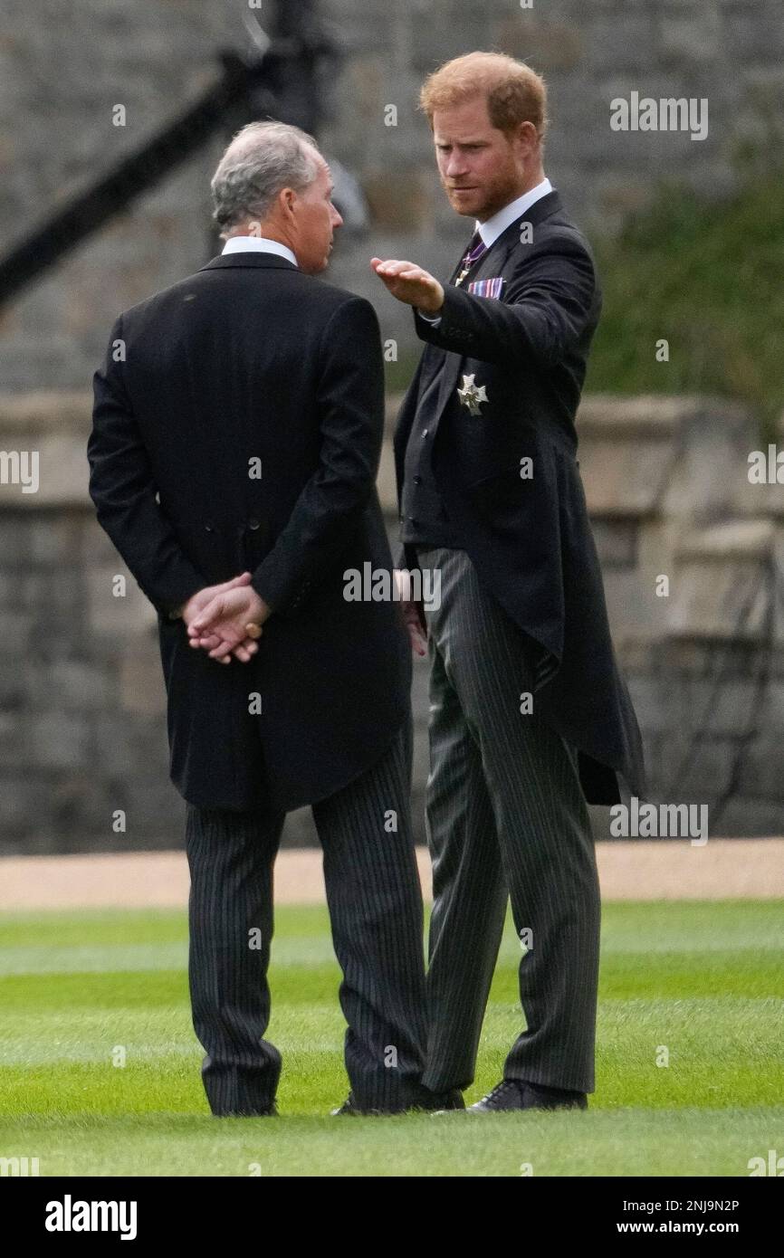 Prince Harry, speaks with the Earl of Snowdon as they arrive for the ...