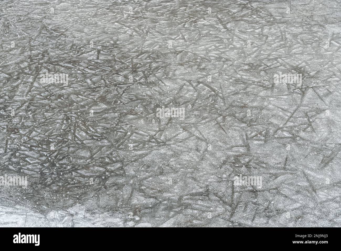 Ice on frozen river forming crystal like structures, closeup macro ...