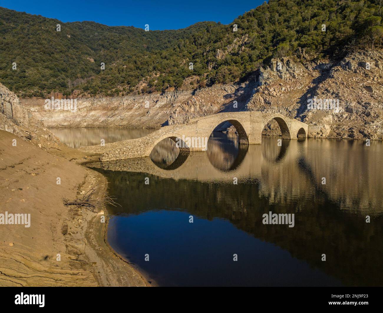 Aerial view of the medieval bridge of Querós, in the Susqueda reservoir ...