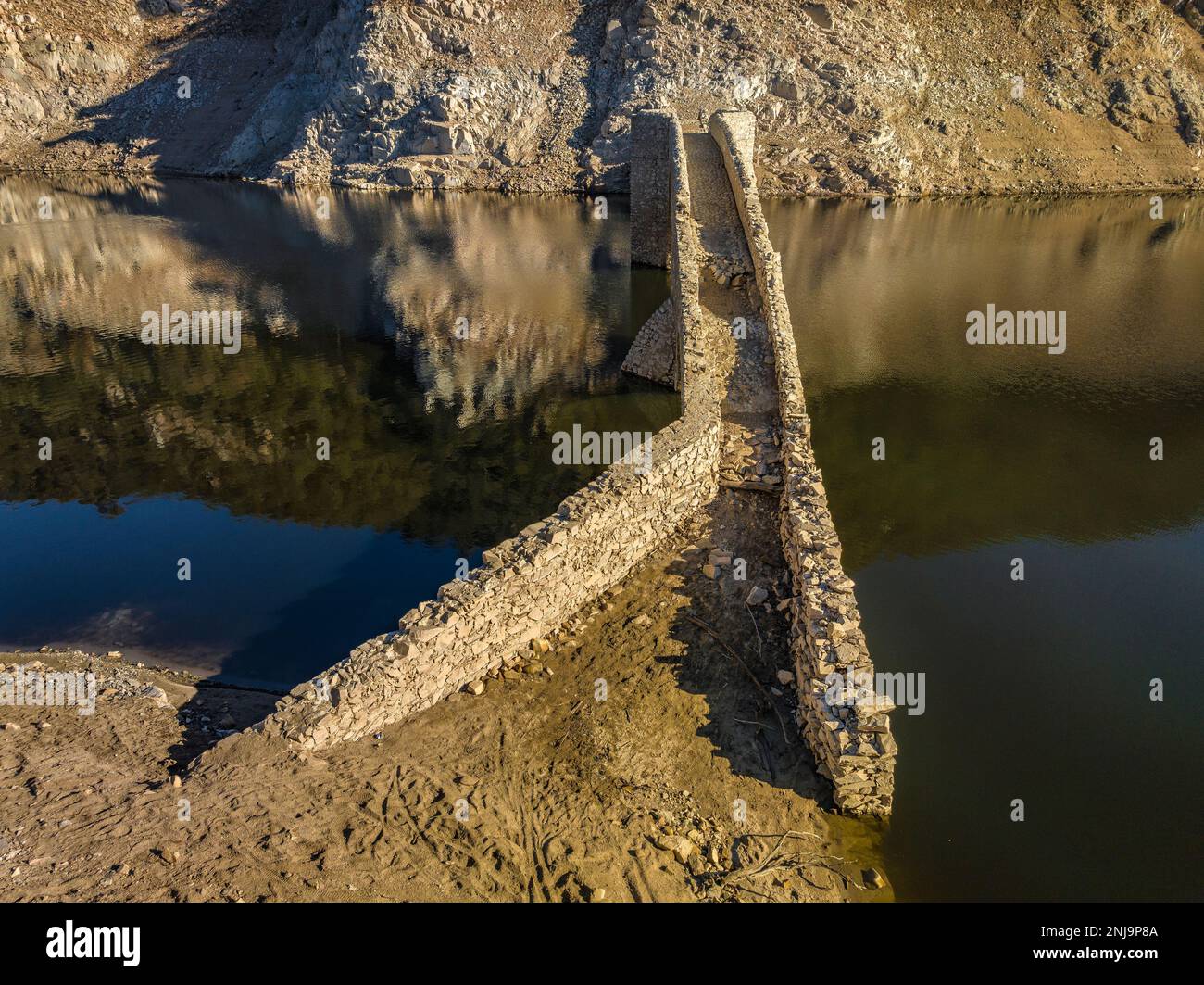 Aerial view of the medieval bridge of Querós, in the Susqueda reservoir ...