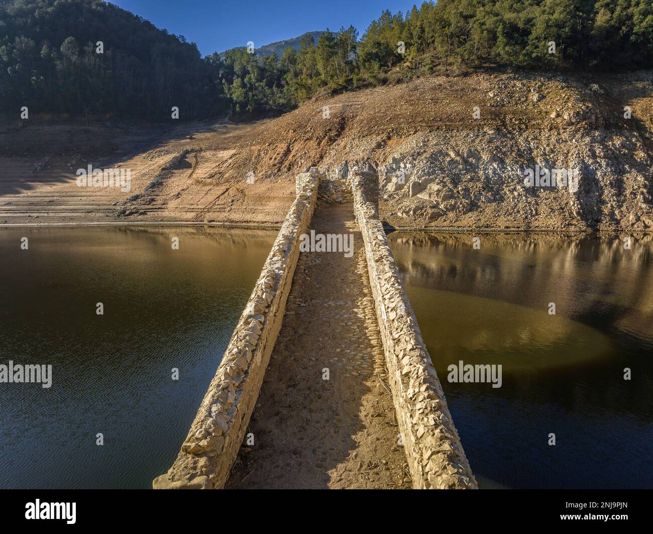 Aerial view of the medieval bridge of Querós, in the Susqueda reservoir ...