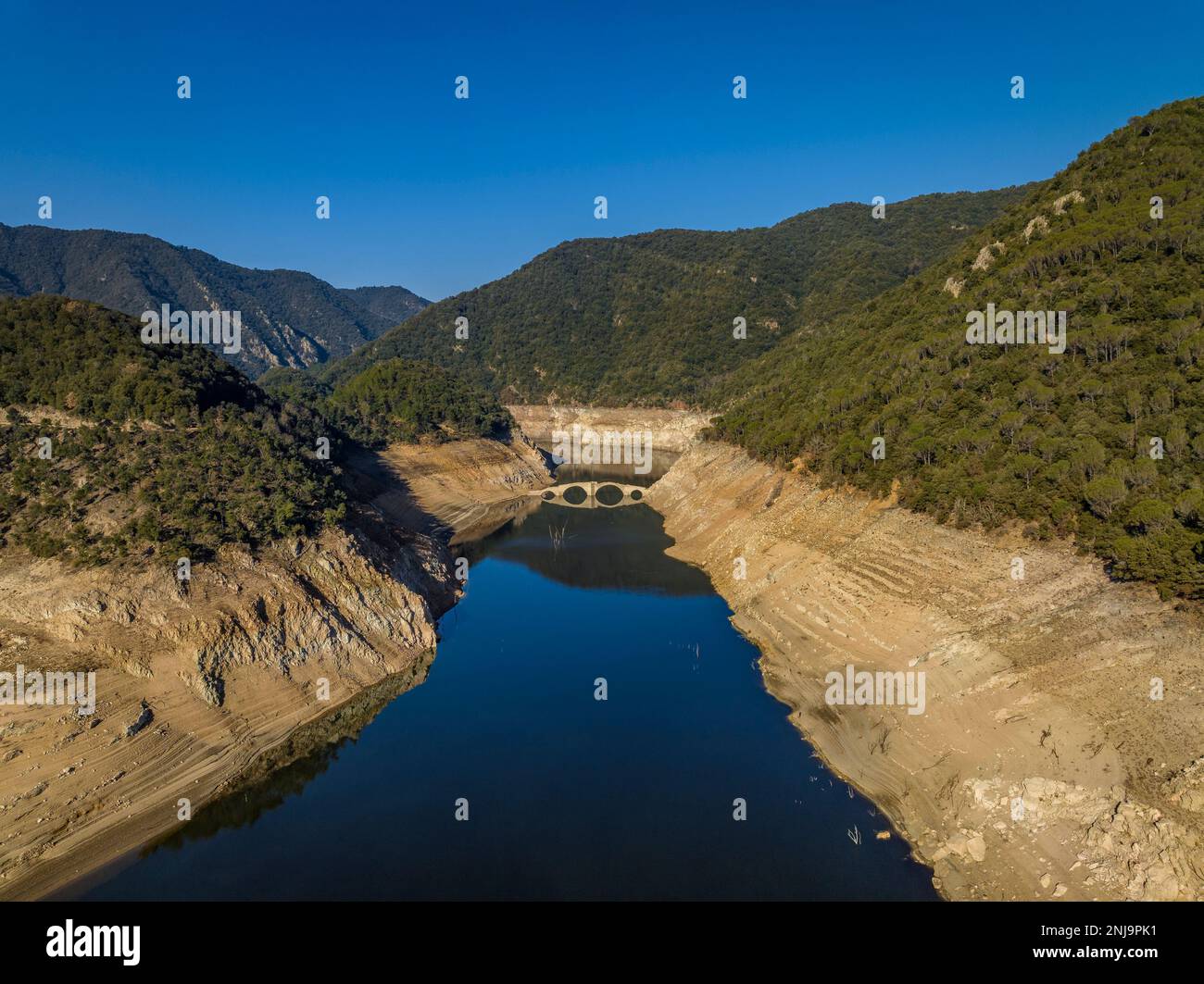 Aerial view of the medieval bridge of Querós, in the Susqueda reservoir ...