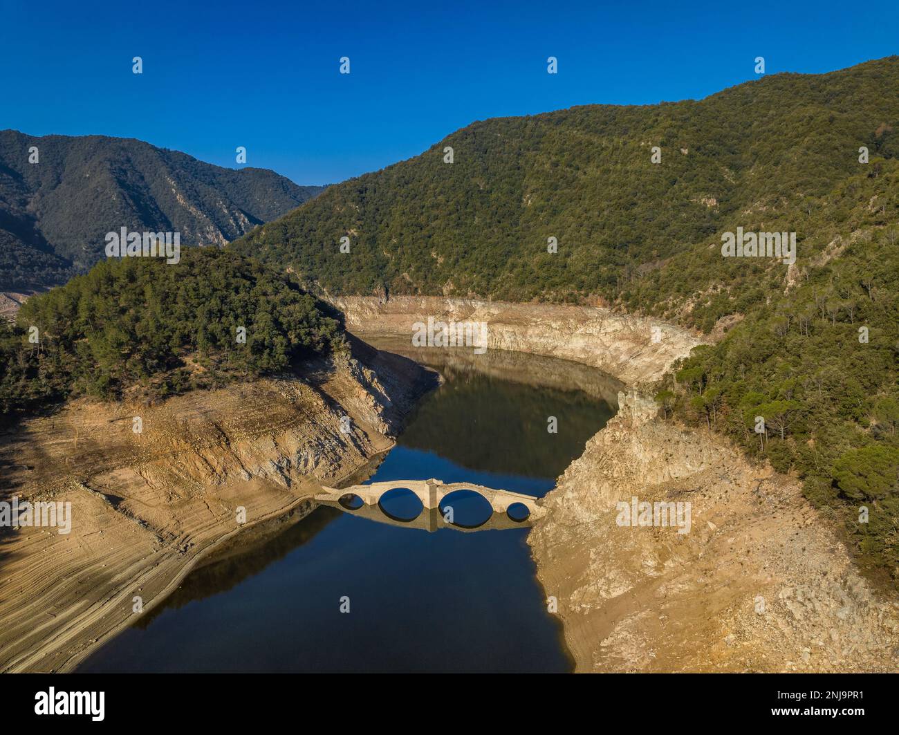 Aerial view of the medieval bridge of Querós, in the Susqueda reservoir ...
