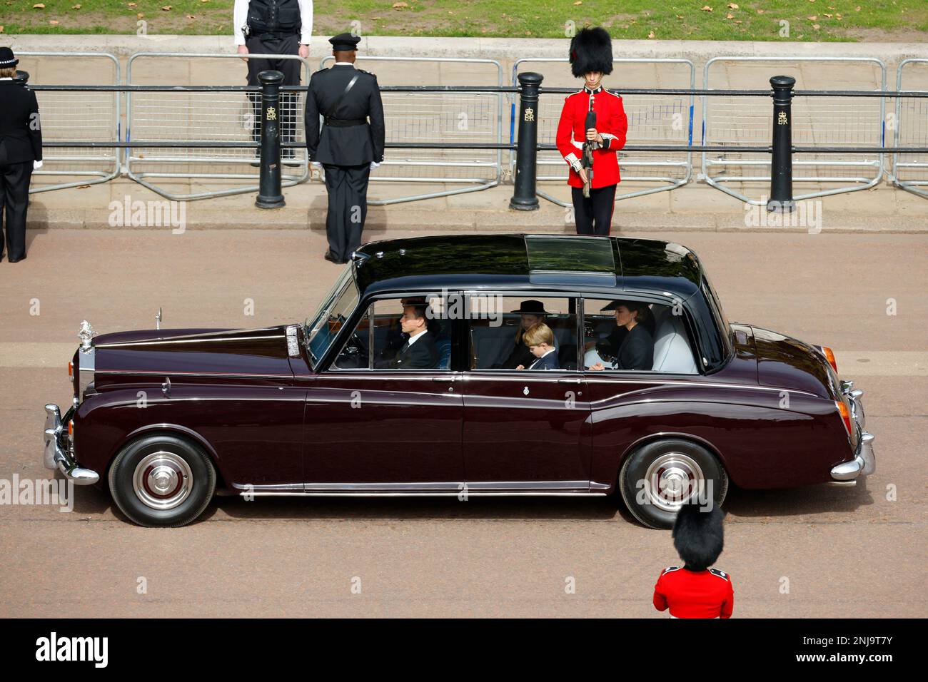 Britain's Prince George, Princess Charlotte and Kate, Princess of Wales are driven in car along ...