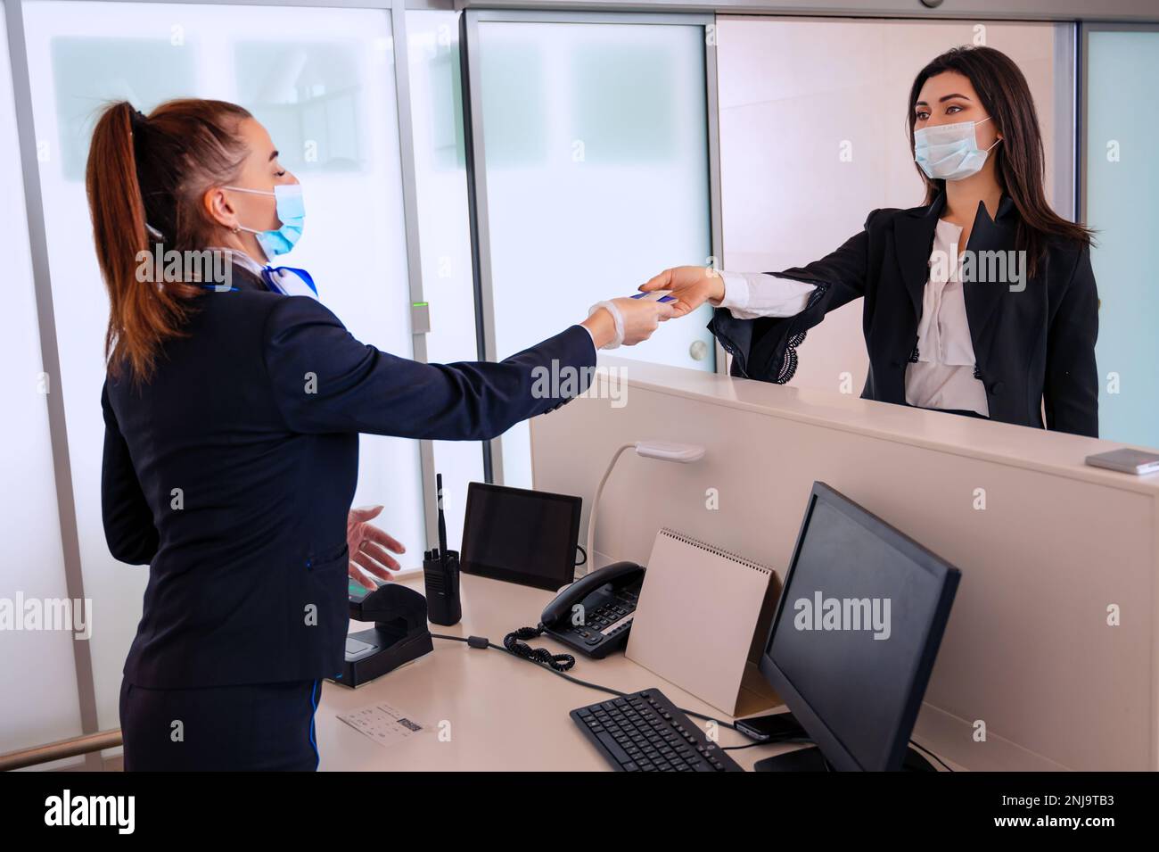Beautiful girl on checking-in her tickets and receiving boarding pass ...