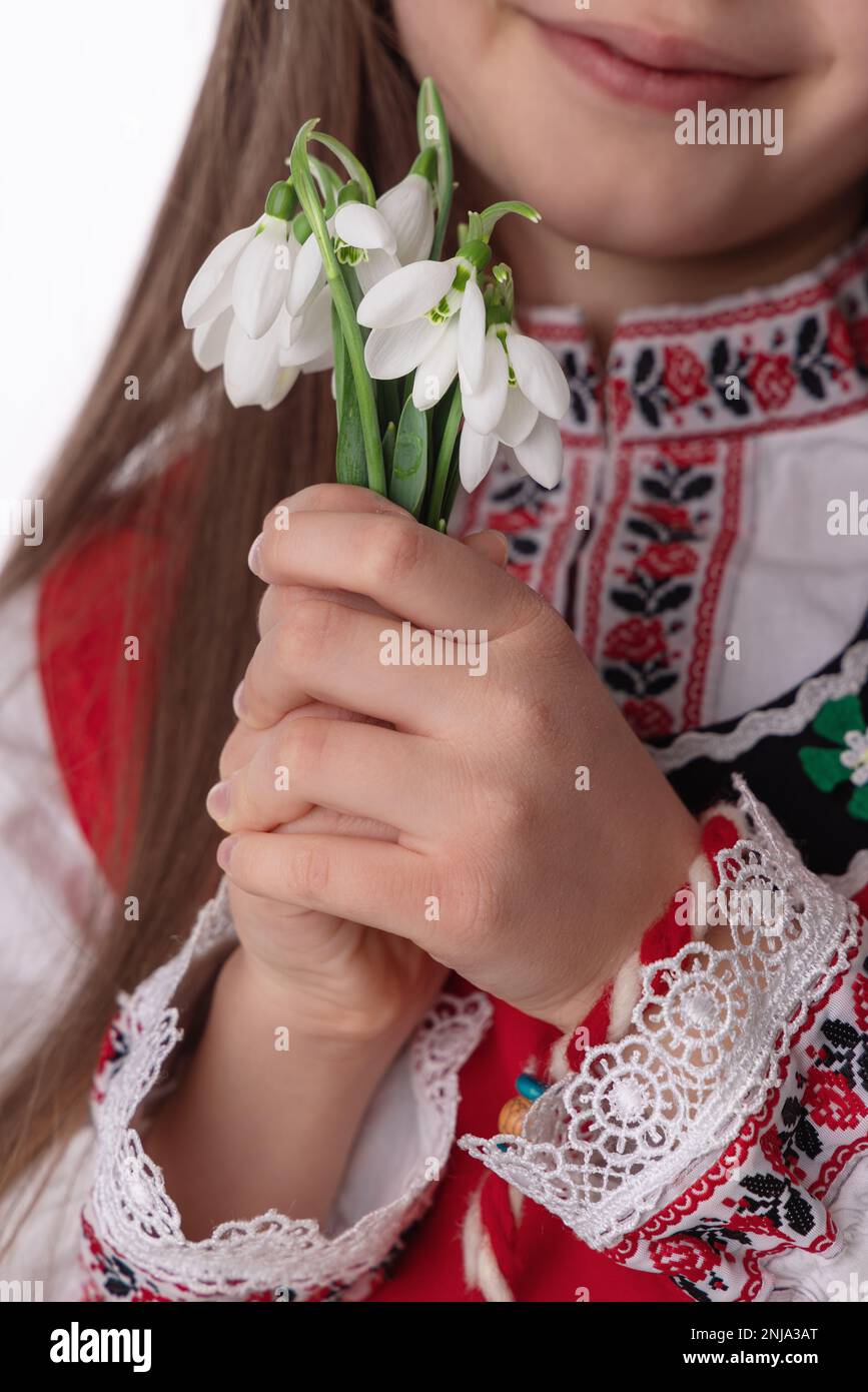 Bulgarian girl in traditional folklore costumes with spring flowers ...