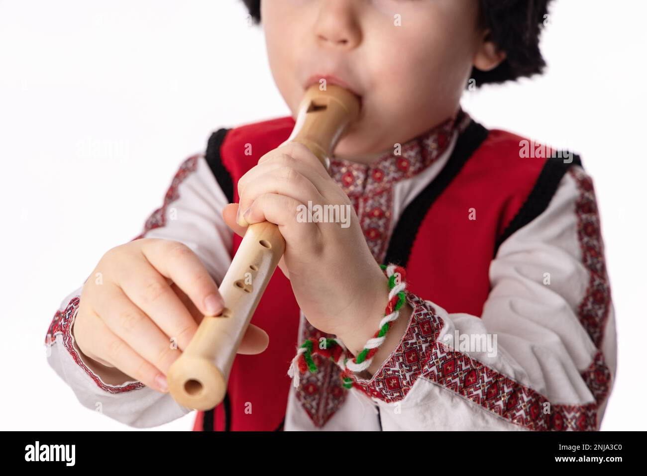 Bulgarian boy in traditional folklore costumes with spring flowers ...