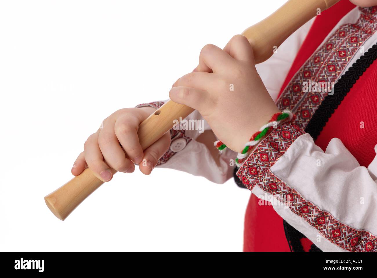 Bulgarian boy in traditional folklore costumes with spring flowers ...