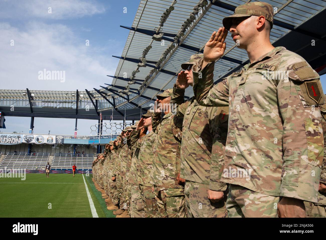 Soldiers with the 1st Infantry Division salute as the national anthem ...