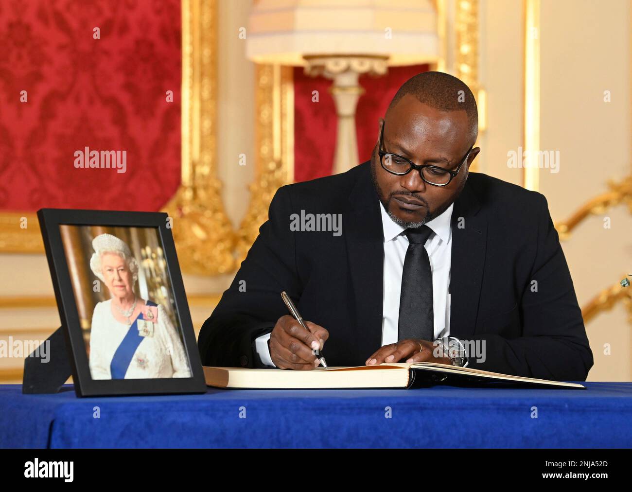 Zambian Minister of Justice, Mulambo Hamakuni Haimbe signs a book of ...
