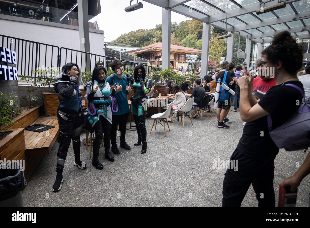 A group of people in costumes have their picture taken at the Valorant ...
