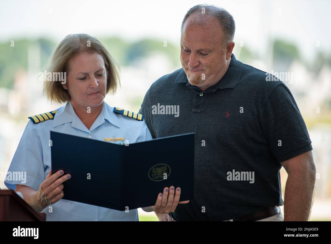 Capt. Kailie Benson, commander Coast Guard Sector Boston, presents a ...