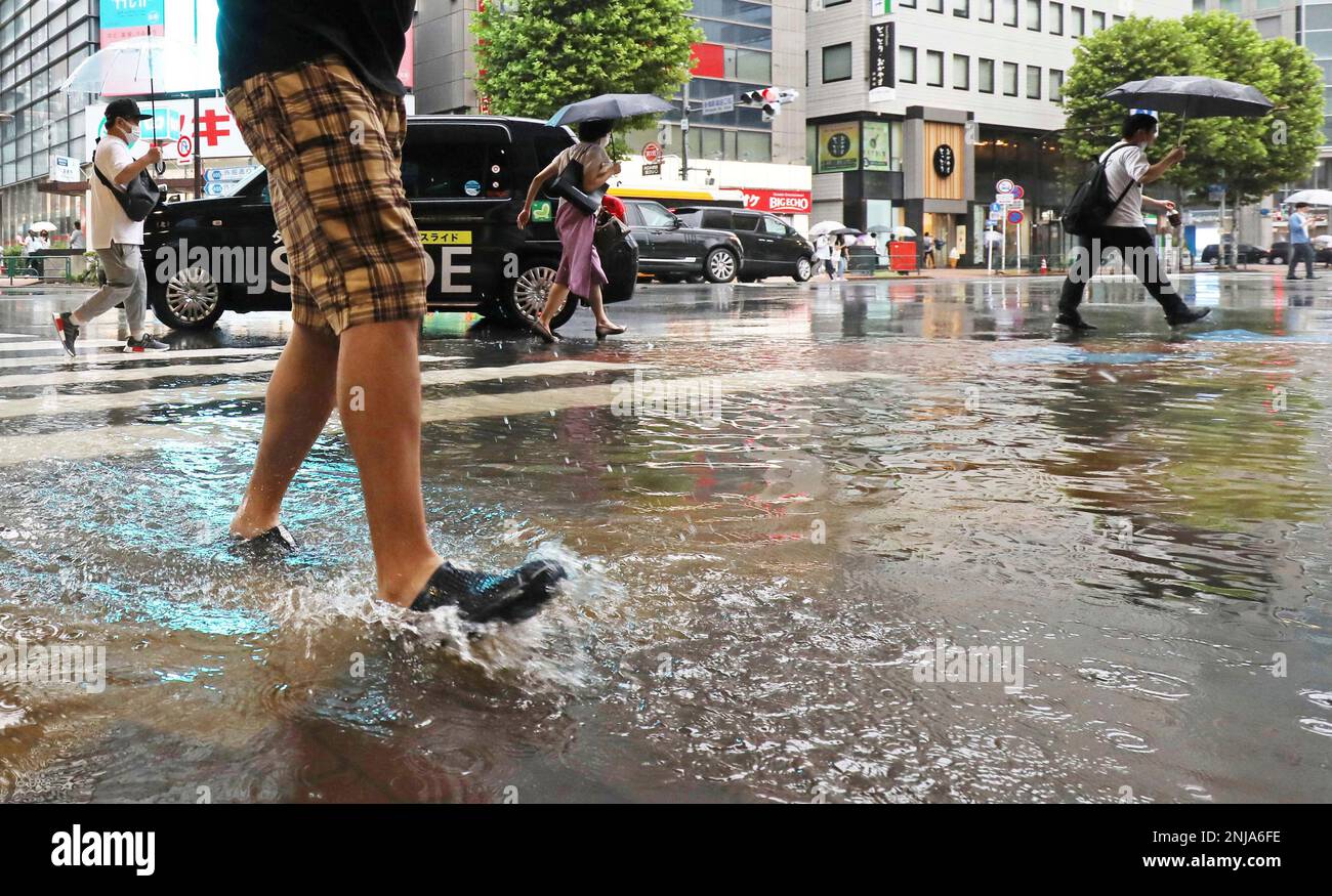 A street is inundated by a heavy rain in Minato Ward, Tokyo on Sept. 18 ...