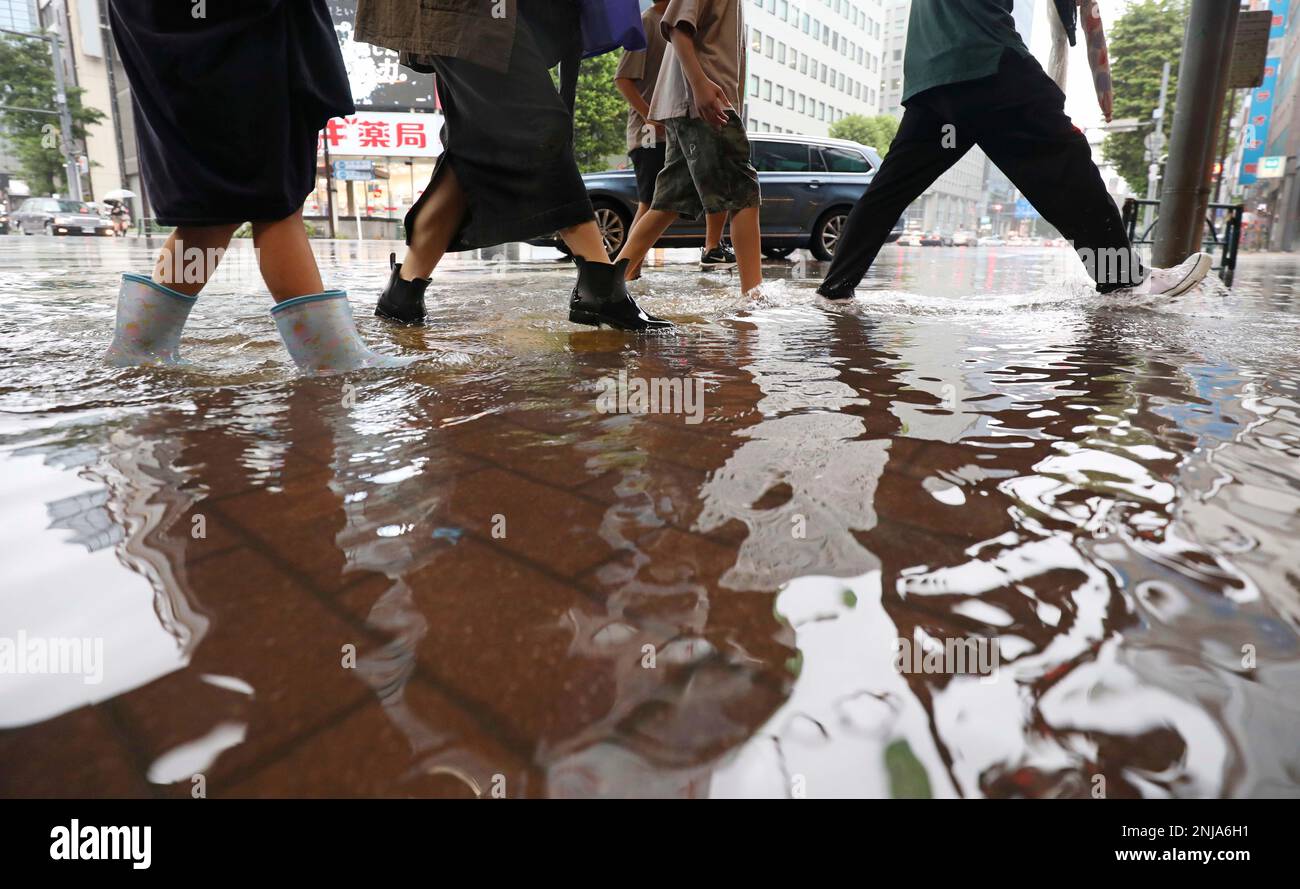 A street is inundated by a heavy rain in Minato Ward, Tokyo on Sept. 18 ...