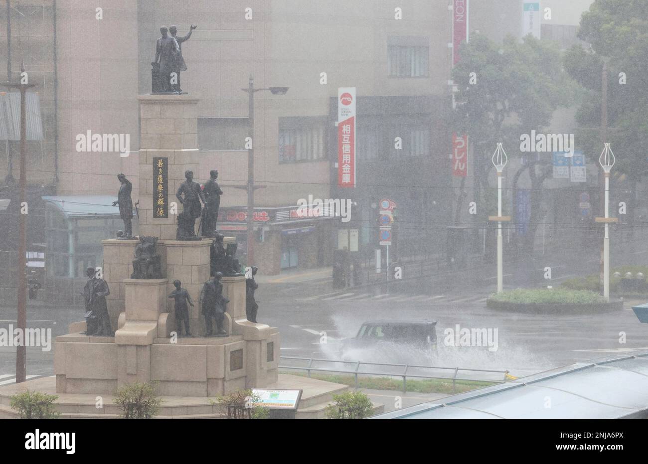 A heavy storm is hitting a street in front of JR Kaoshima Chuo Station ...