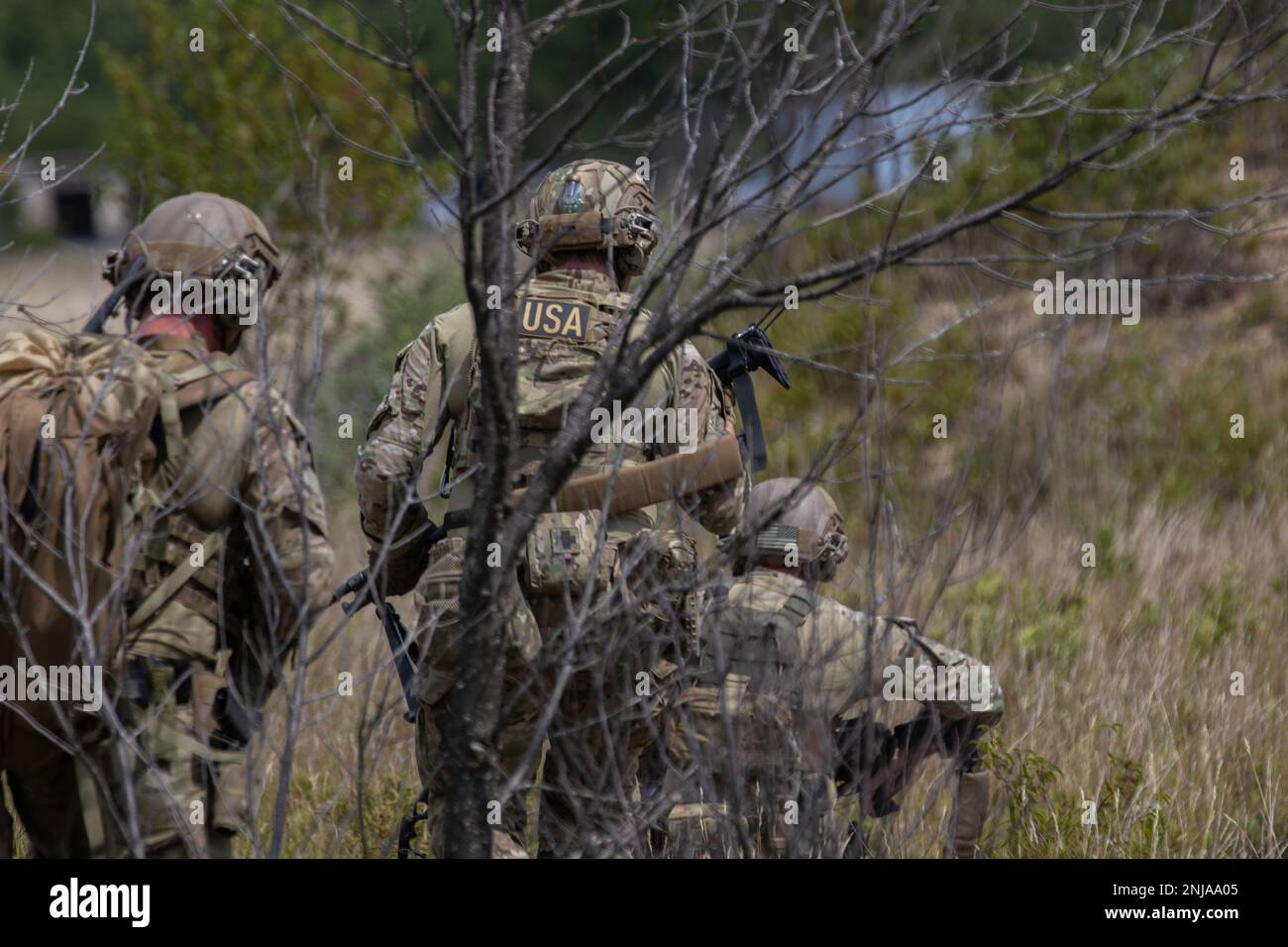 Operators from the 20th Special Forces Group run to a landing site to ...