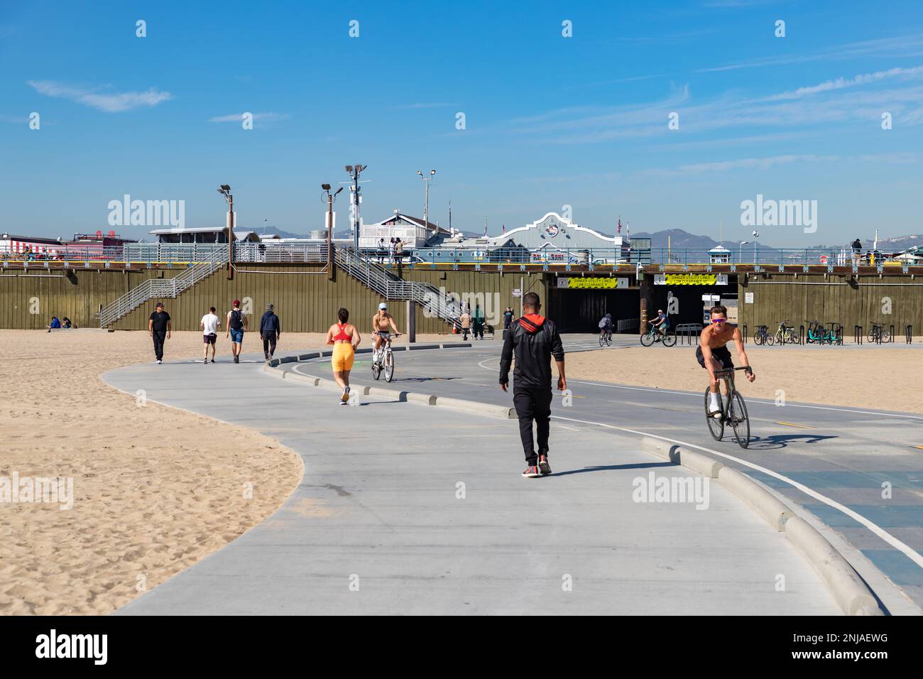 A picture of the iconic Santa Monica Beach boardwalk with people ...