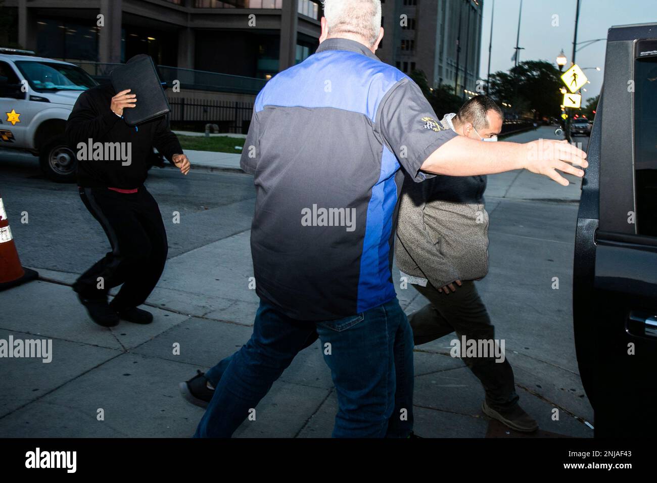 Police officer Ruben Reynoso, in grey jacket, and Sgt. Christopher ...