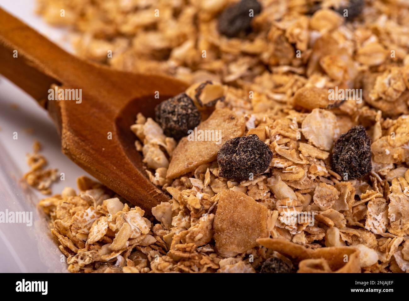 A close-up of a bowl of homemade-style granola with whole grains, nuts ...