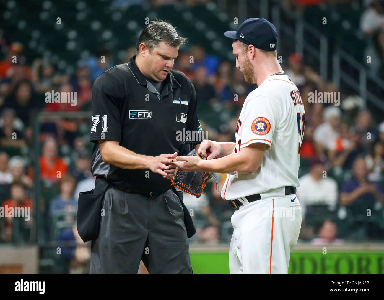 HOUSTON, TX - SEPTEMBER 15: Home plate umpire Jordan Baker (71) checks ...