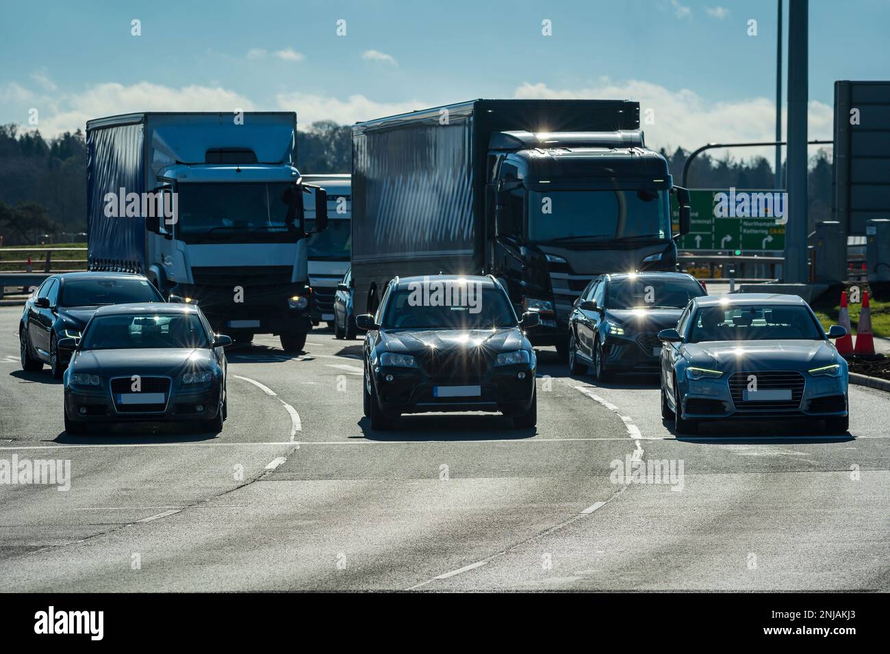 Cars and trucks stopped at junction traffic light on motorway in ...