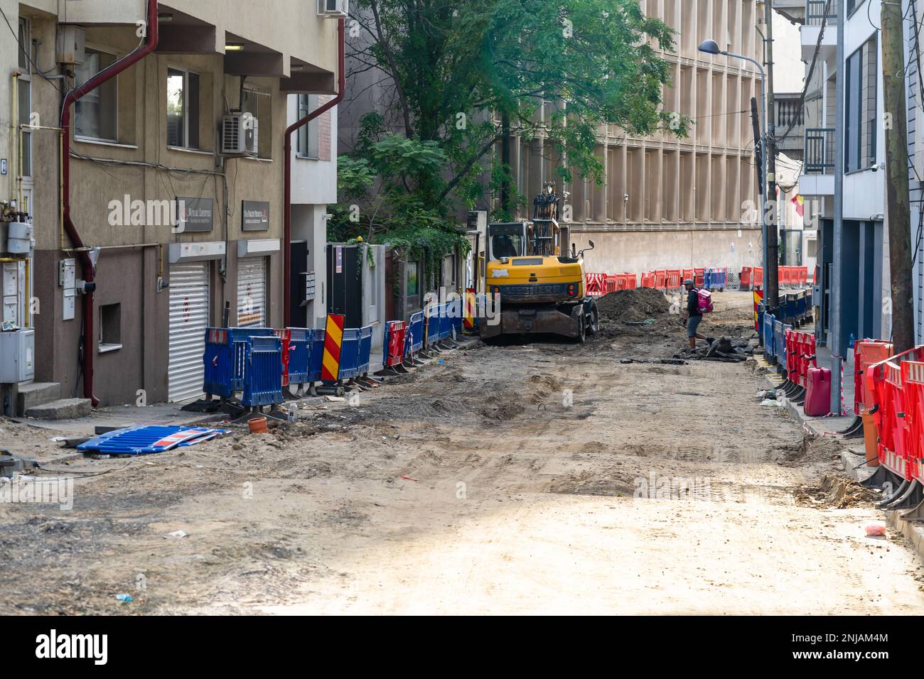 Construction workers at construction site and heavy duty bulldozer in ...
