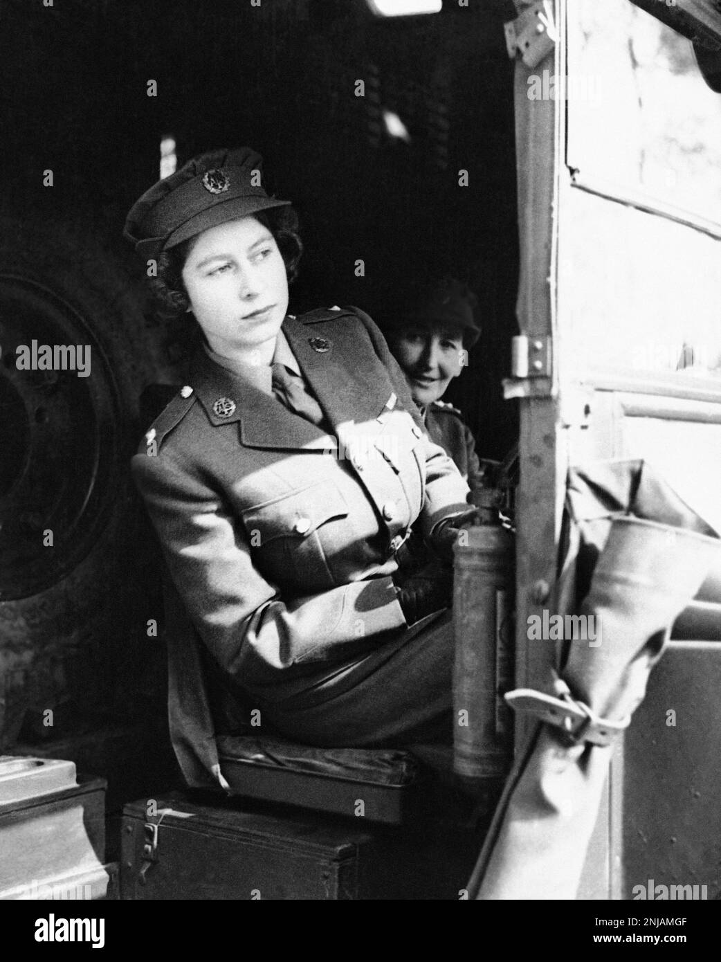 FILE - Britain's Princess Elizabeth sits at the driving wheel of an ...