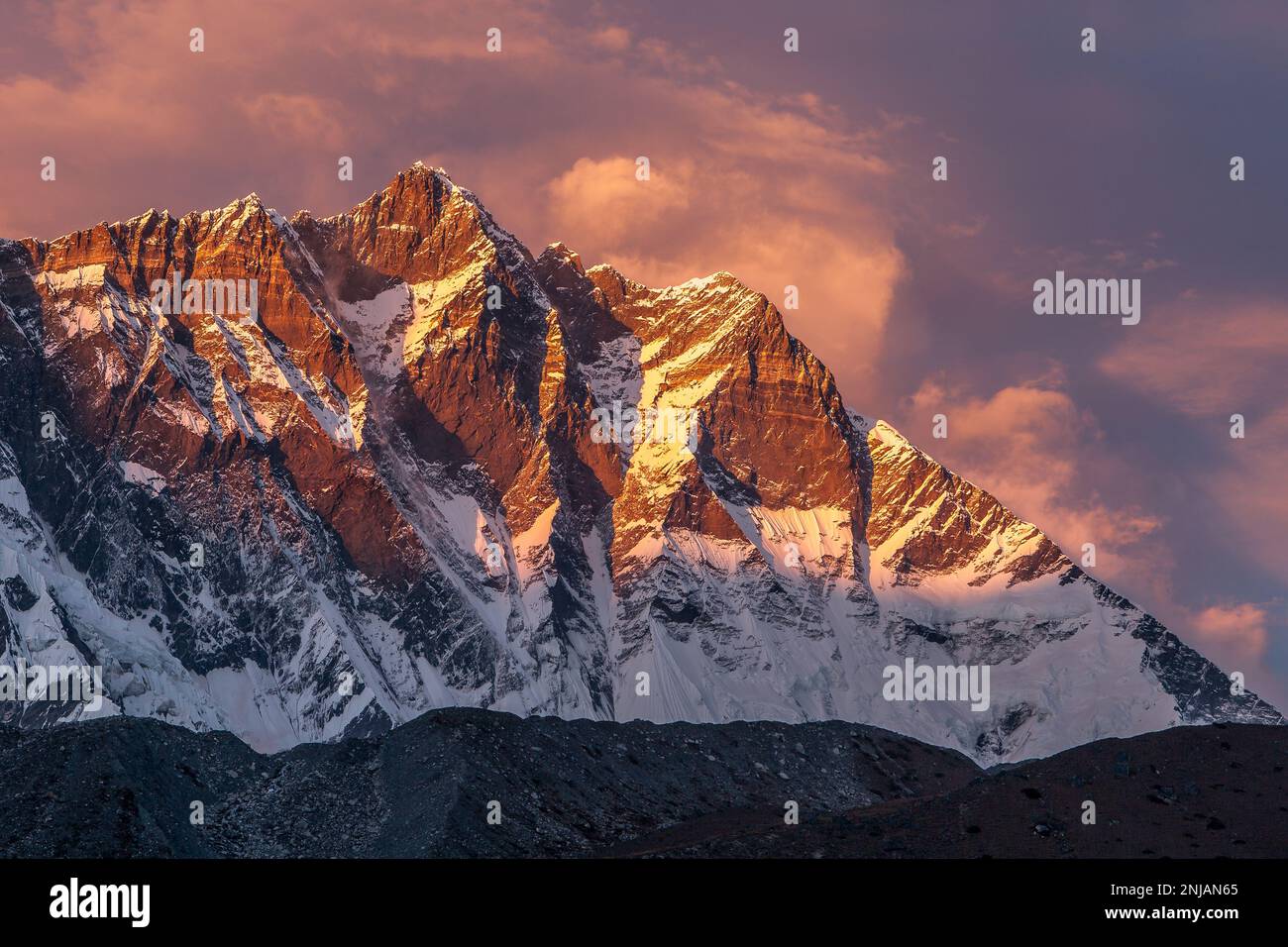 Beautiful sunset with pinkish clouds over Himalayan mountains. Lhotse ...