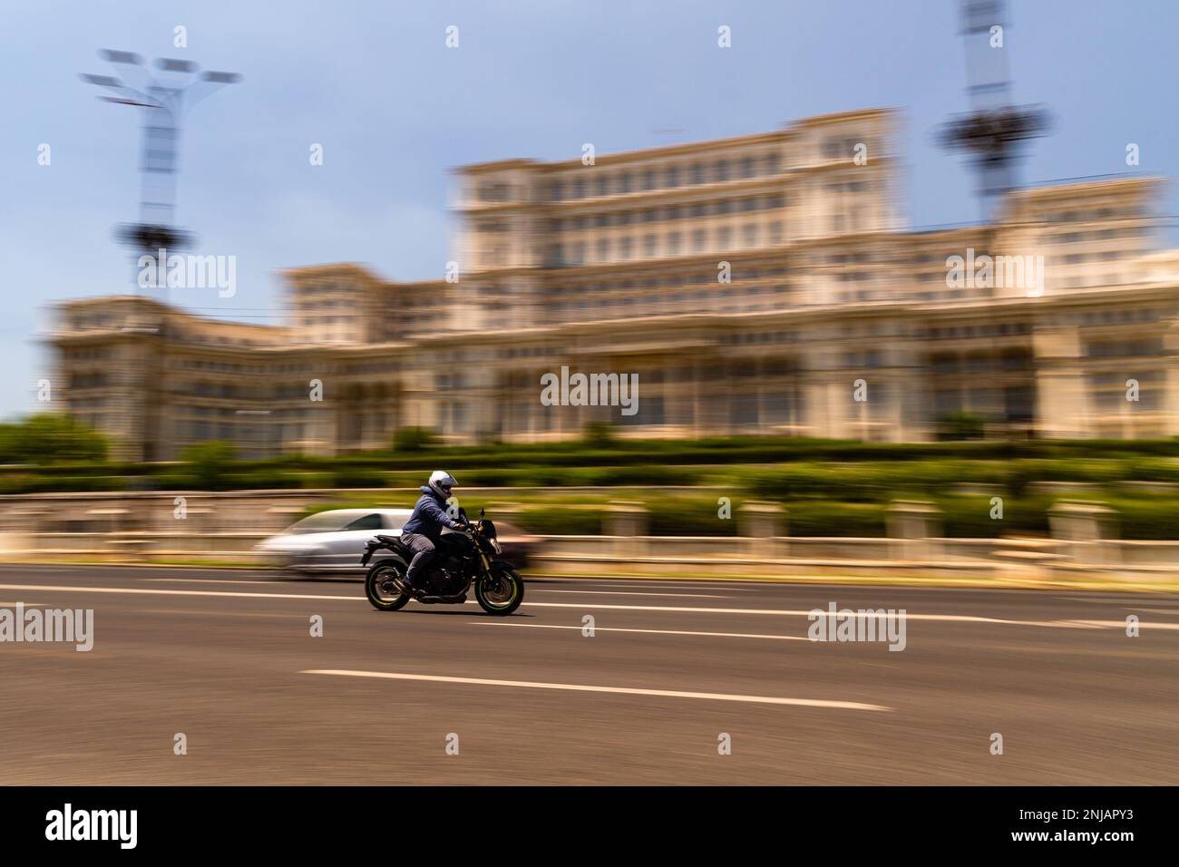 Biker on a motorcycle in traffic at rush hour in downtown area of the ...