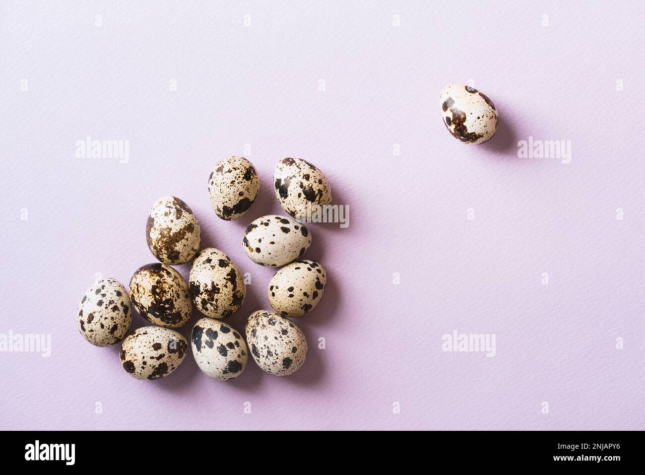Pile of quail eggs on purple background Stock Photo - Alamy