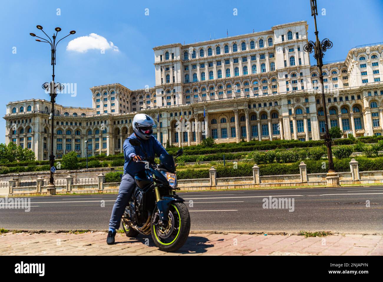 Biker on a motorcycle in traffic at rush hour in downtown area of the ...