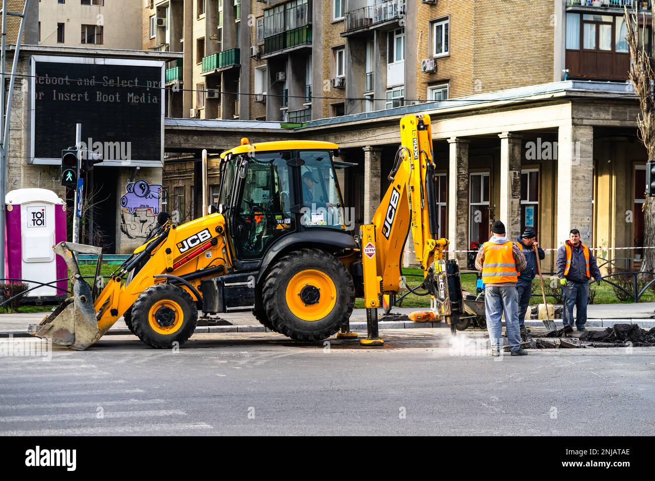 Excavator in traffic. industrial equipment at construction site in ...