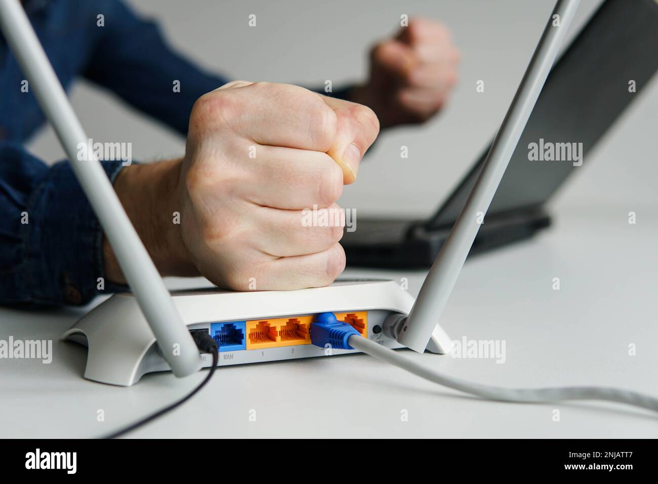 Frustrated young man angry at his wifi router modem at work Stock Photo ...