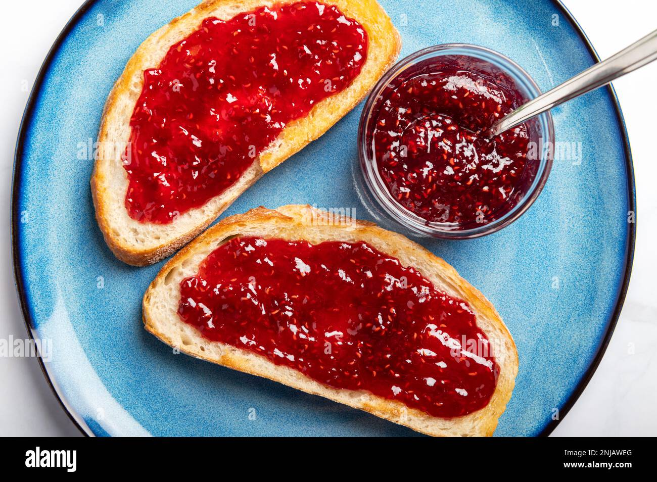Raspberry jam on toast Stock Photo - Alamy