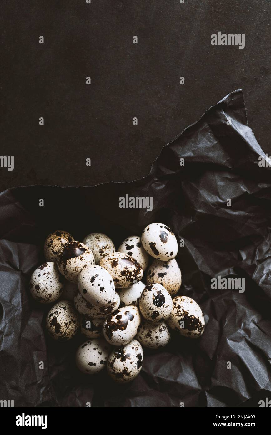 Eggs wrapped in black wrapping paper on black background Stock Photo ...