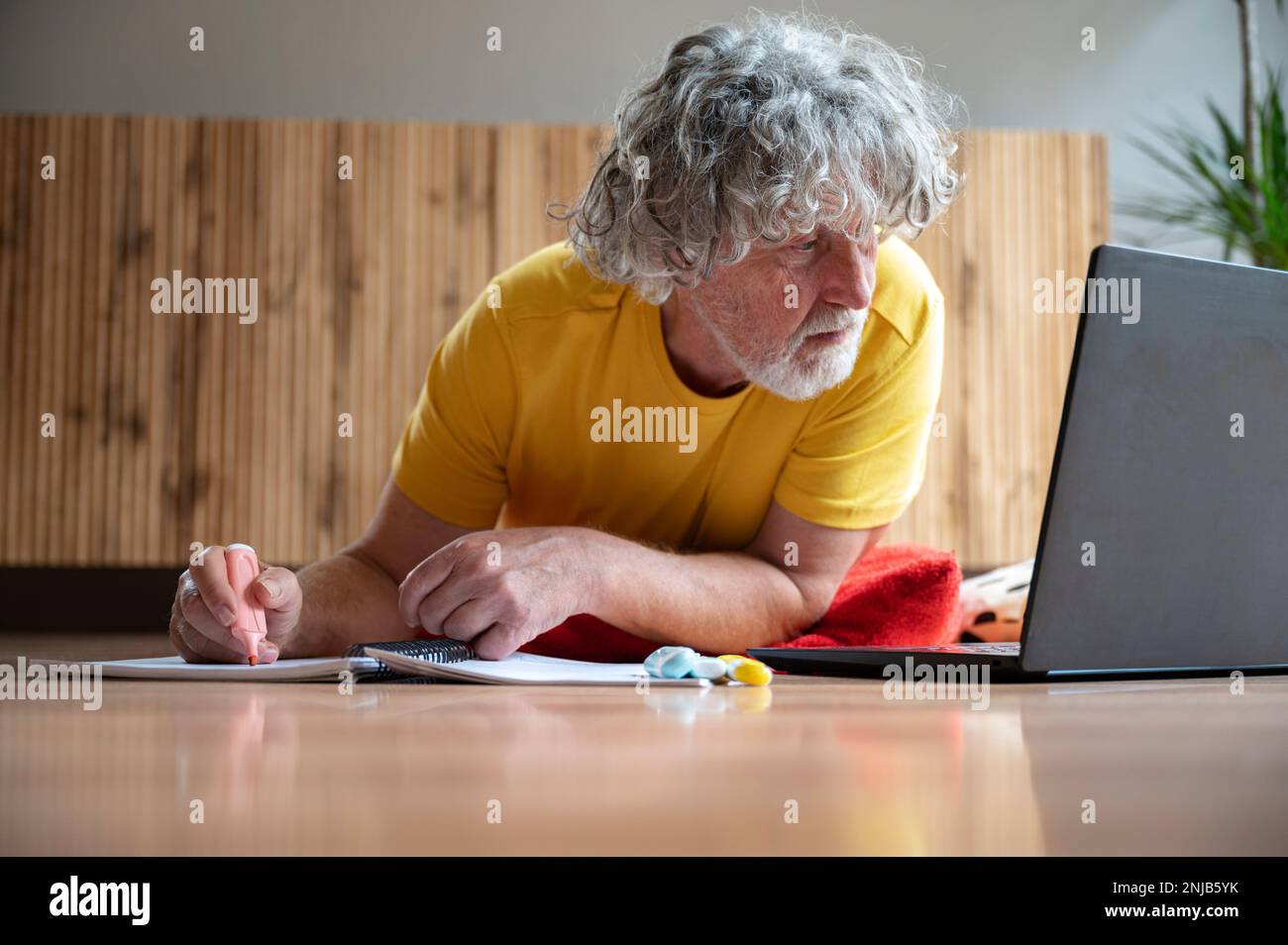 Man on computer making notes hi-res stock photography and images - Alamy