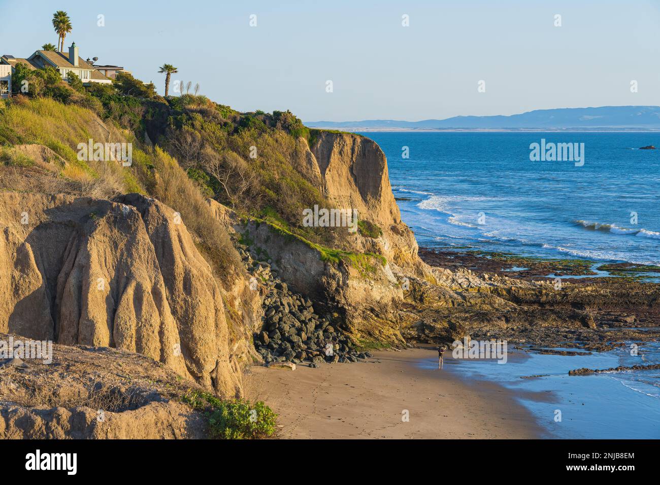 Pismo Beach cliffs at sunset and ocean view with clear blue sky in the ...
