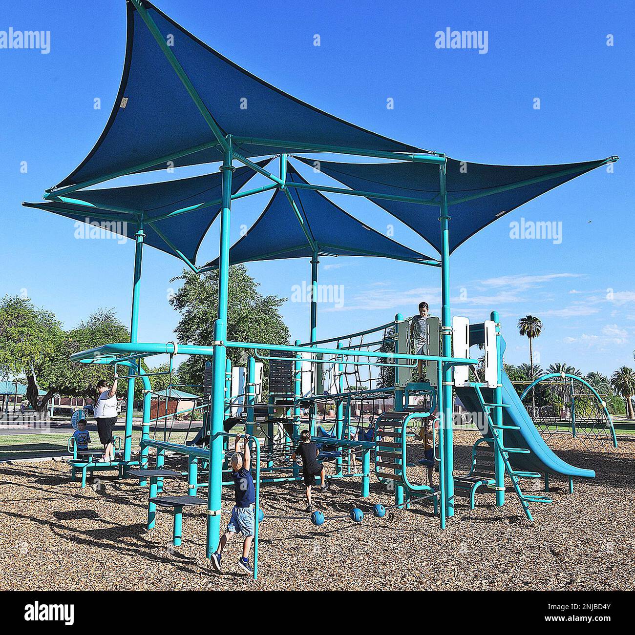 Children play on the new playground equipment at Caballero Park ...