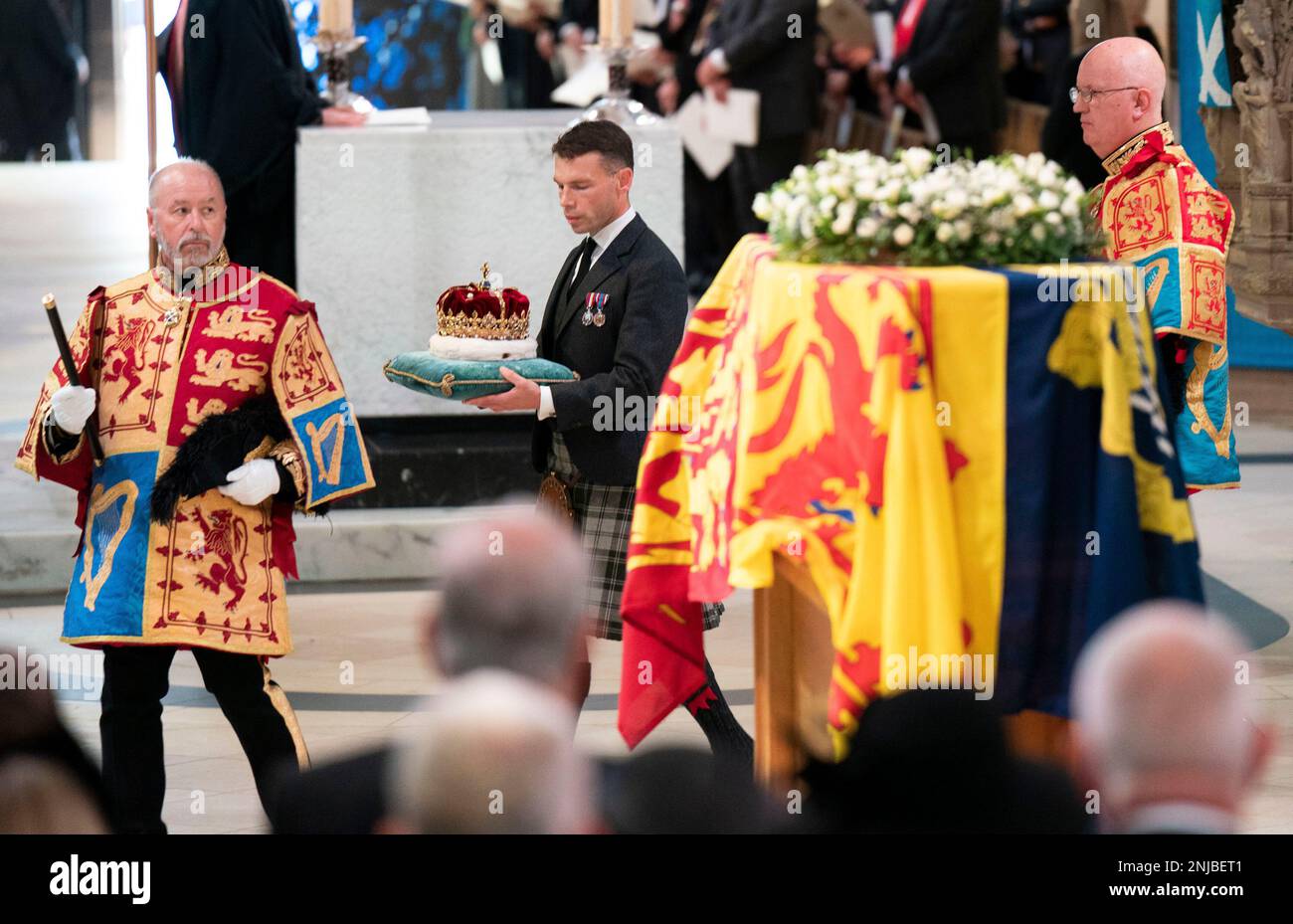 The Duke of Hamilton, center, carries the Crown of Scotland to be ...