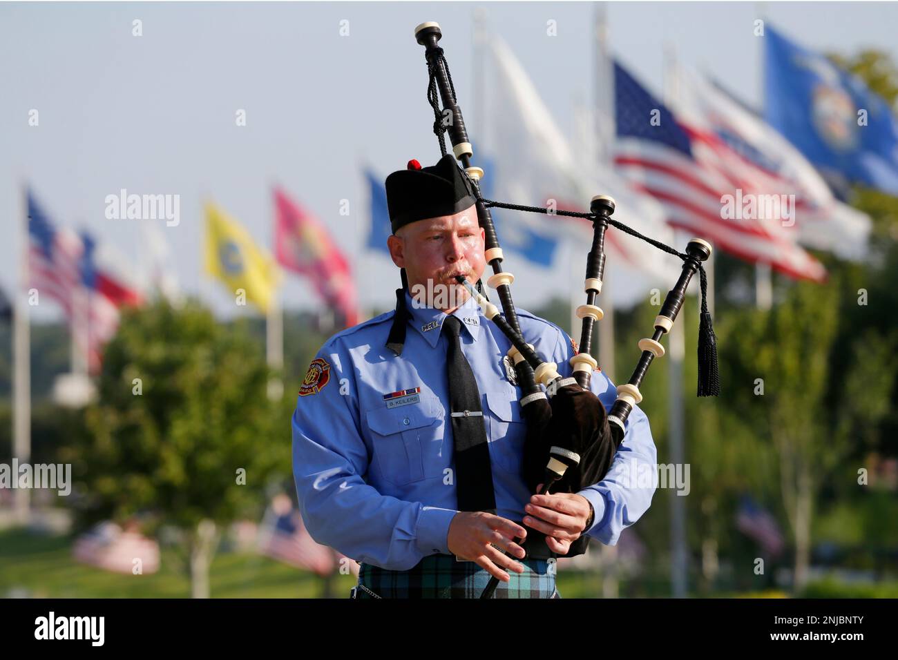 Brandon Keilers plays "Amazing Grace" on bagpipes during a September ...