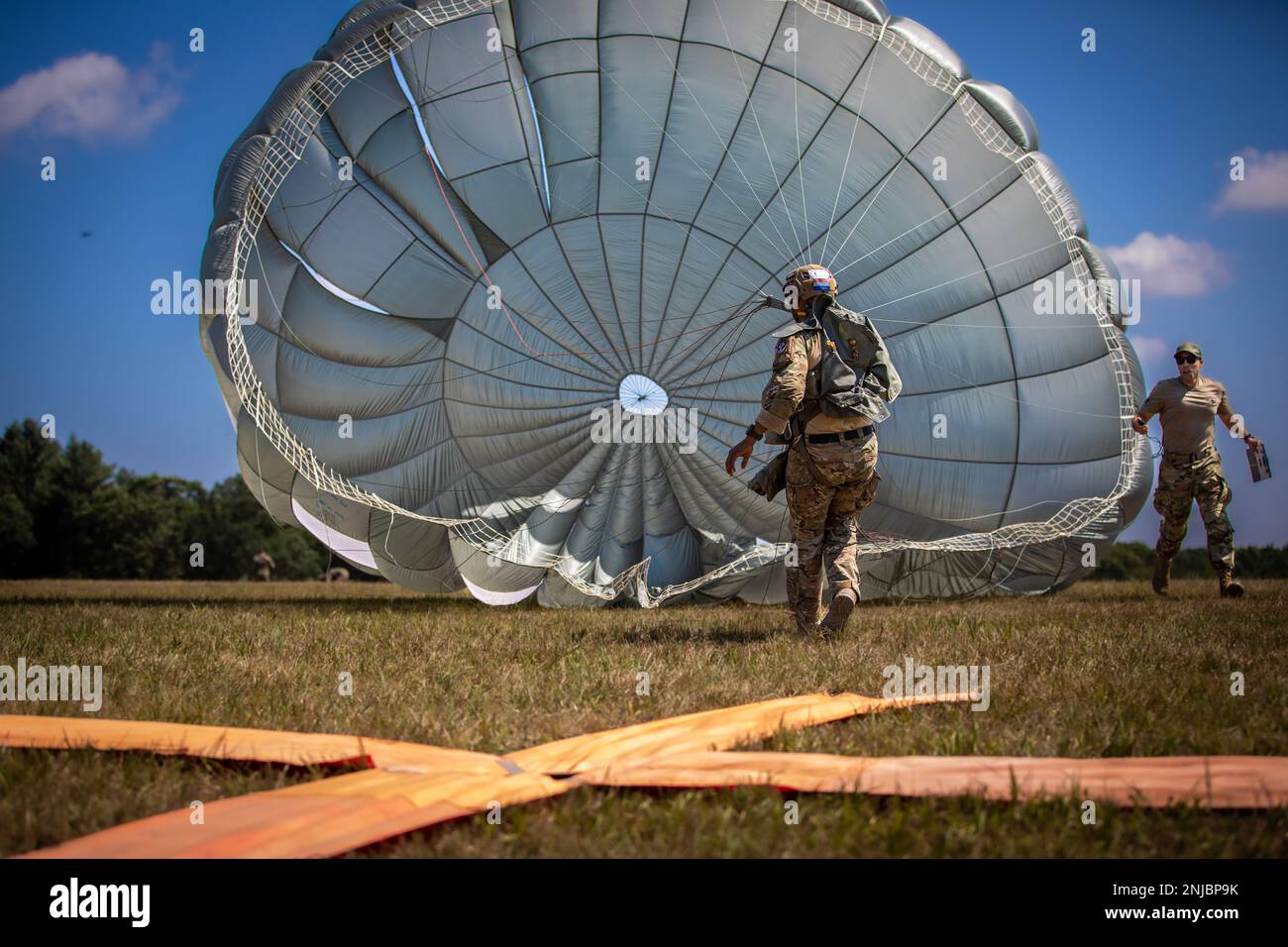 A Dutch Paratrooper drags his MC-6 parachute towards the objective on ...