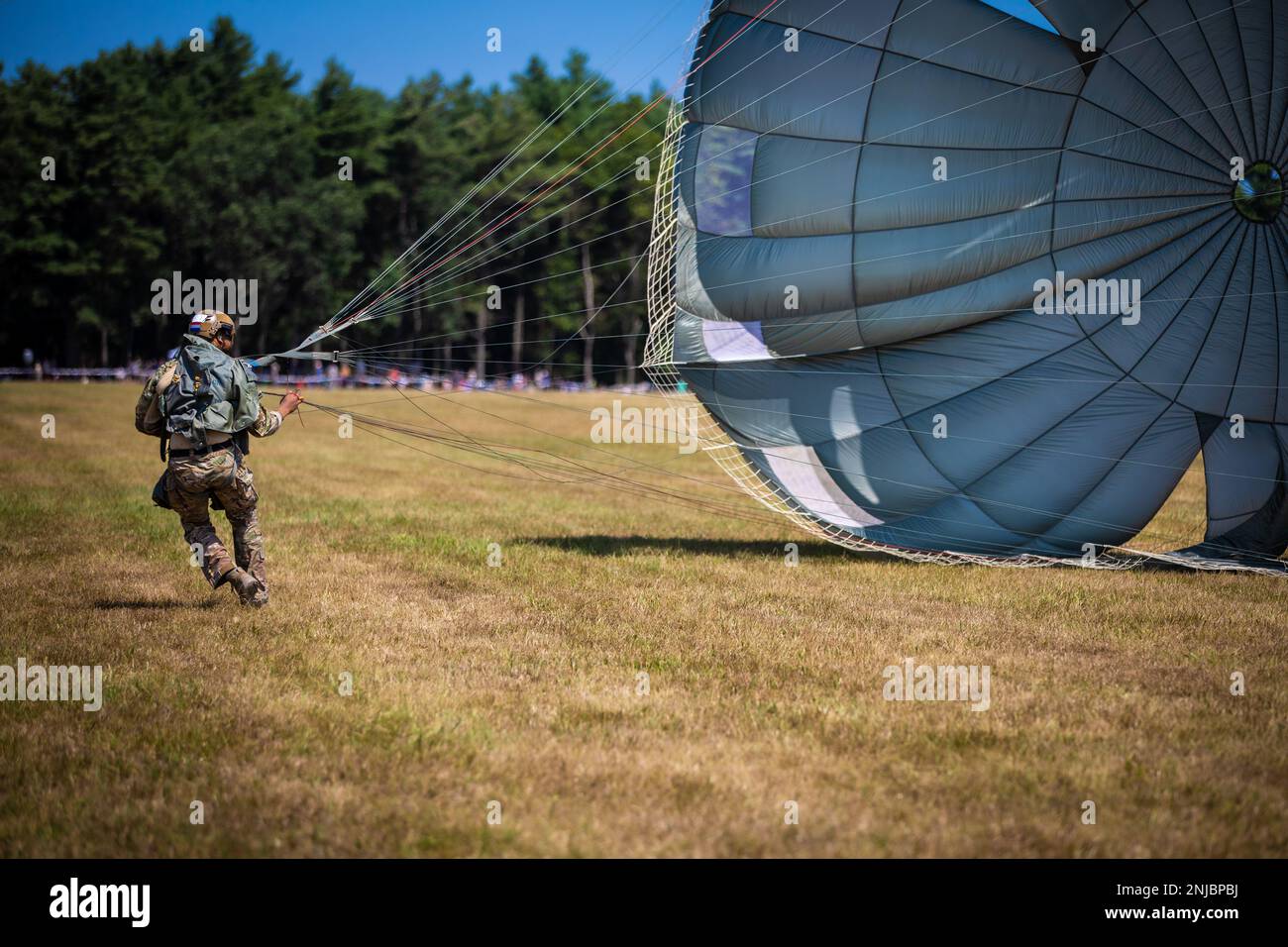 A Dutch Paratrooper drags his MC-6 parachute towards the objective on ...