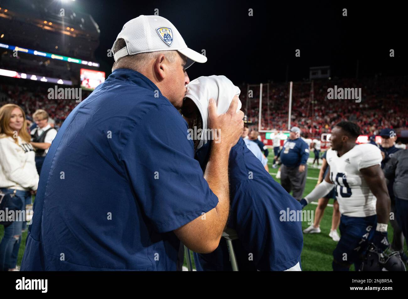 Georgia Southern head coach Clay Helton kisses Georgia Southern's Sam Kenerson (0) on the head ...