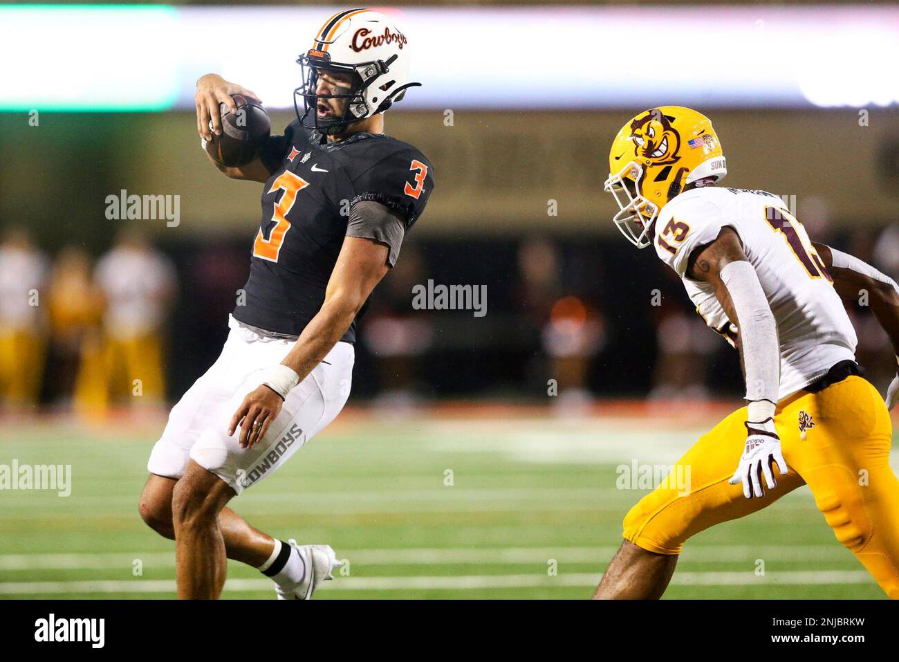 Oklahoma State quarterback Spencer Sanders (3) runs out of bounds with ...