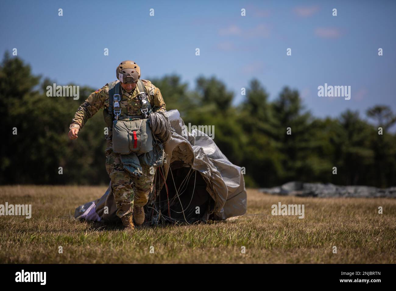 A U.S. Army Paratrooper runs and drags his MC-6 parachute towards the ...
