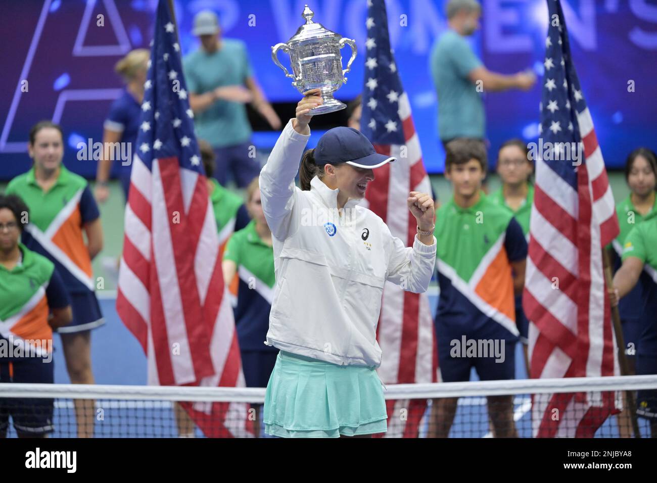 Iga Swiatek poses with the trophy during a women's singles championship ...
