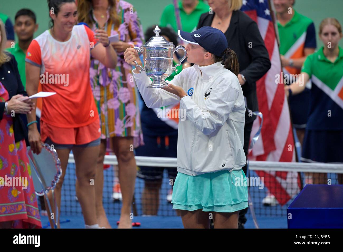 Iga Swiatek poses with the trophy during a women's singles championship ...