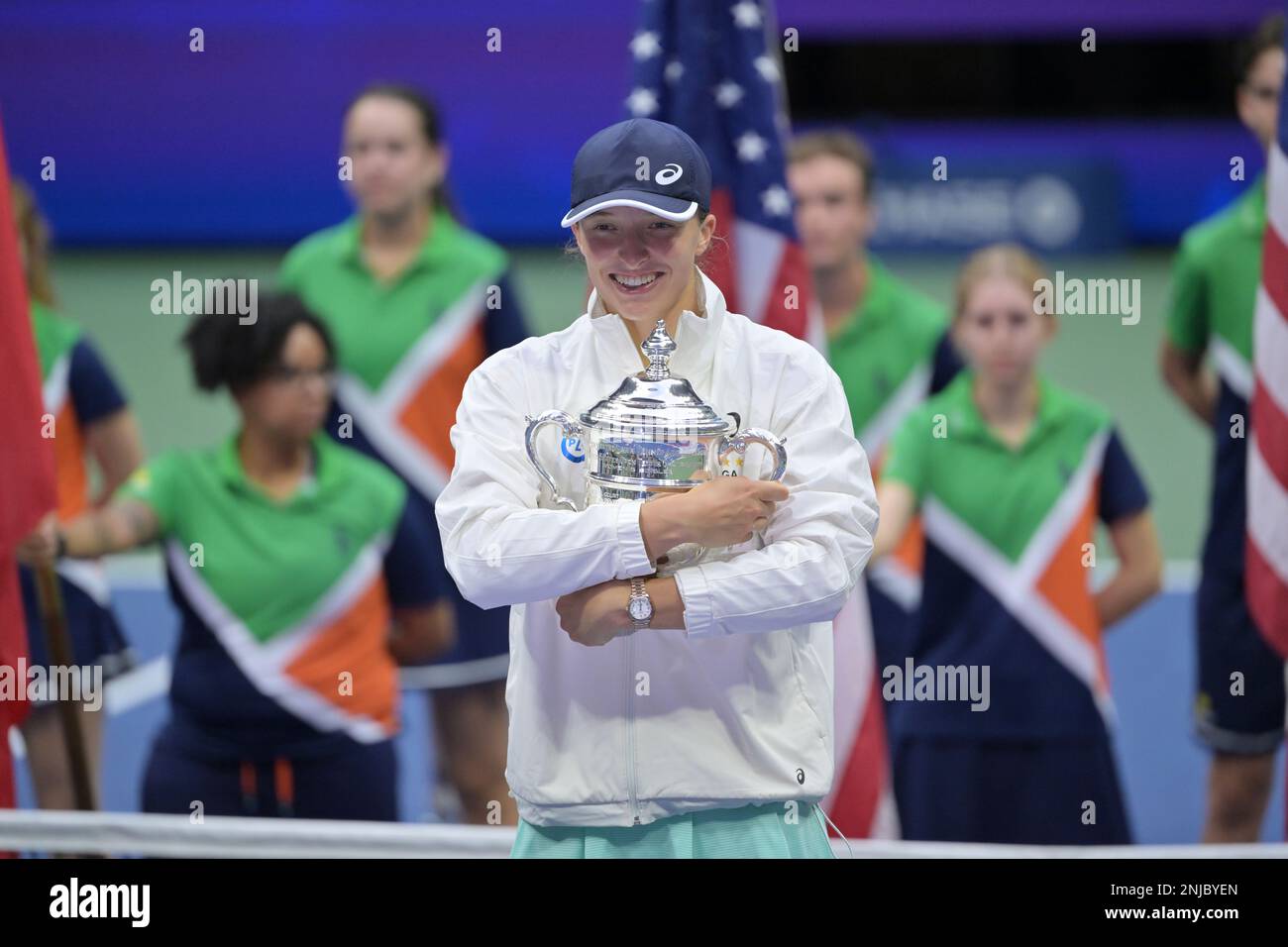 Iga Swiatek poses with the trophy during a women's singles championship ...