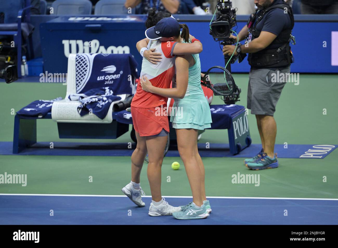 Iga Swiatek and Ons Jabeur hug during a women's singles championship match at the 2022 US Open ...